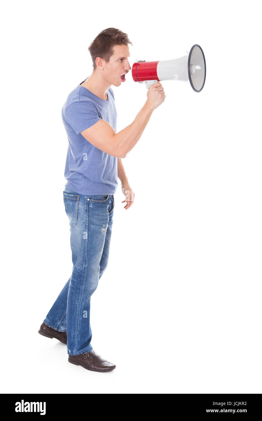 Portrait Of Young Man Shouting Through Megaphone Over White Background ...