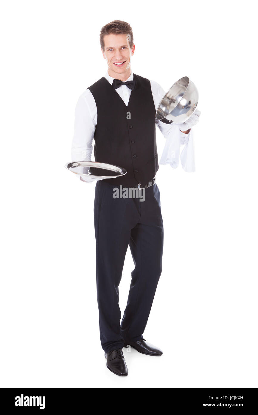 Happy male waiter opening cloche hi-res stock photography and images ...