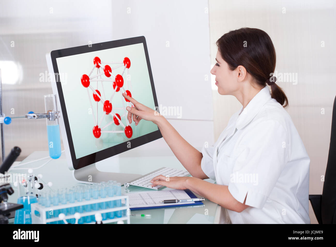 Female Scientist Touching Computer Screen In Lab Stock Photo - Alamy