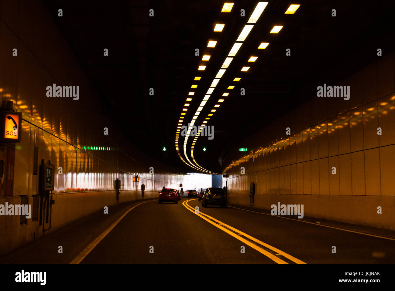 cars driving through a tunnel under the city Stock Photo - Alamy