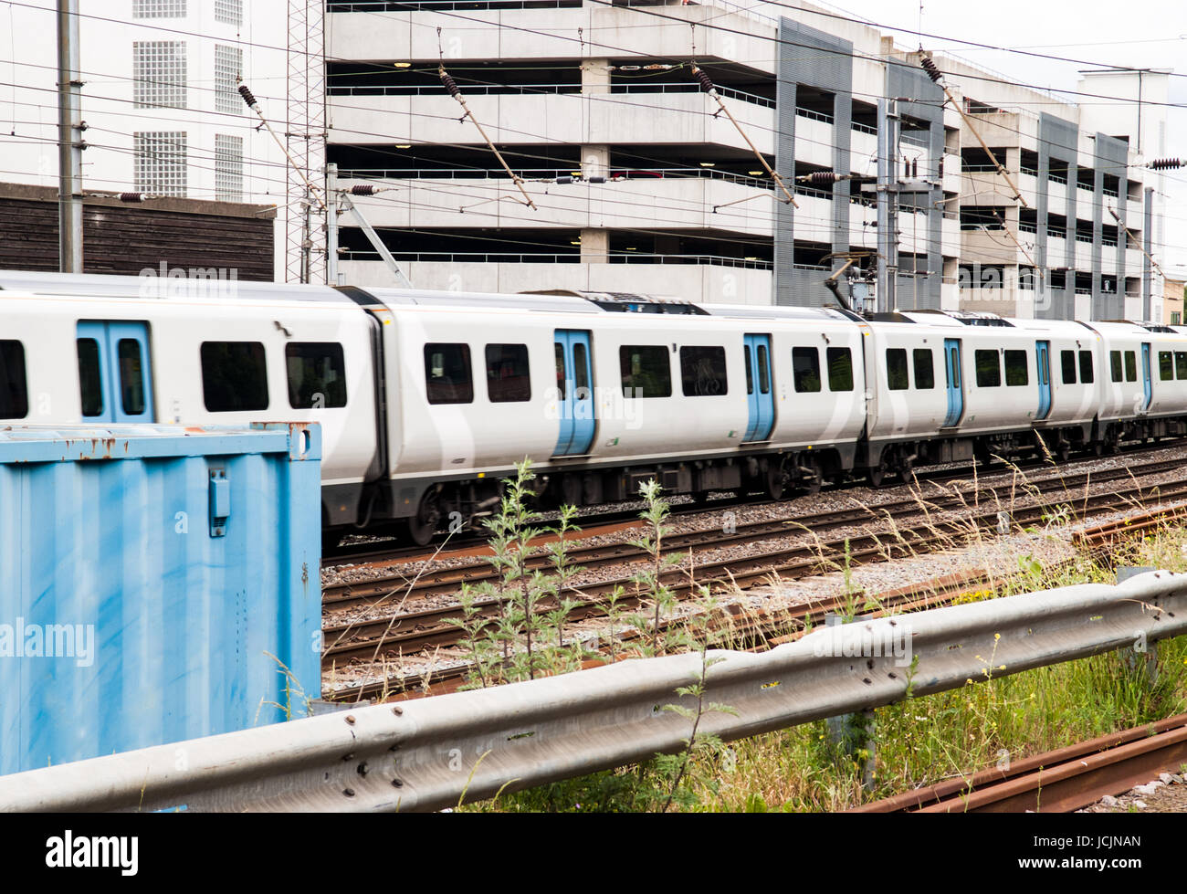 Train on a railway line through a city background Stock Photo - Alamy