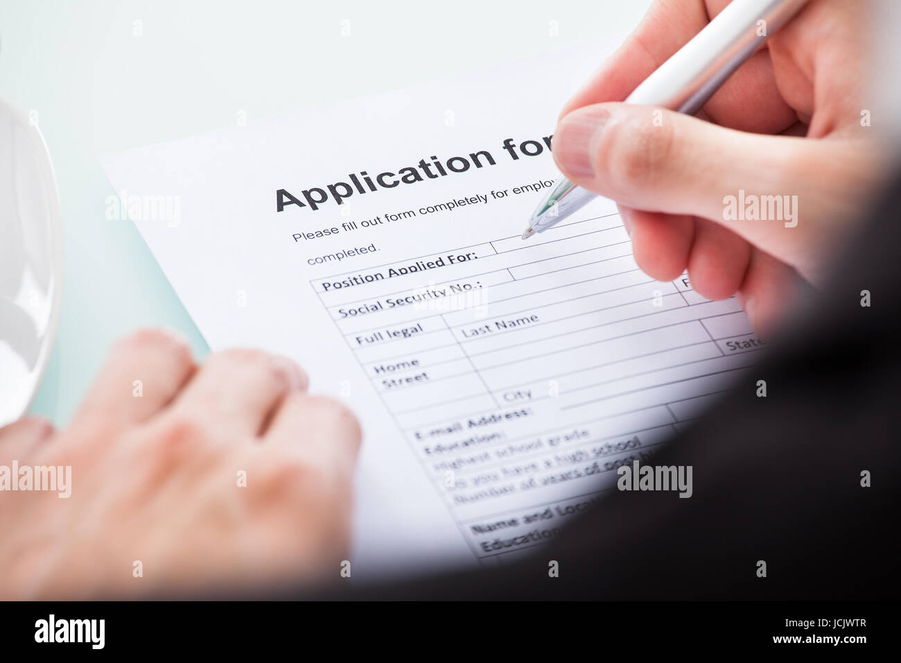 Close-up Of Man's Hand Filling Application For Employment Stock Photo ...