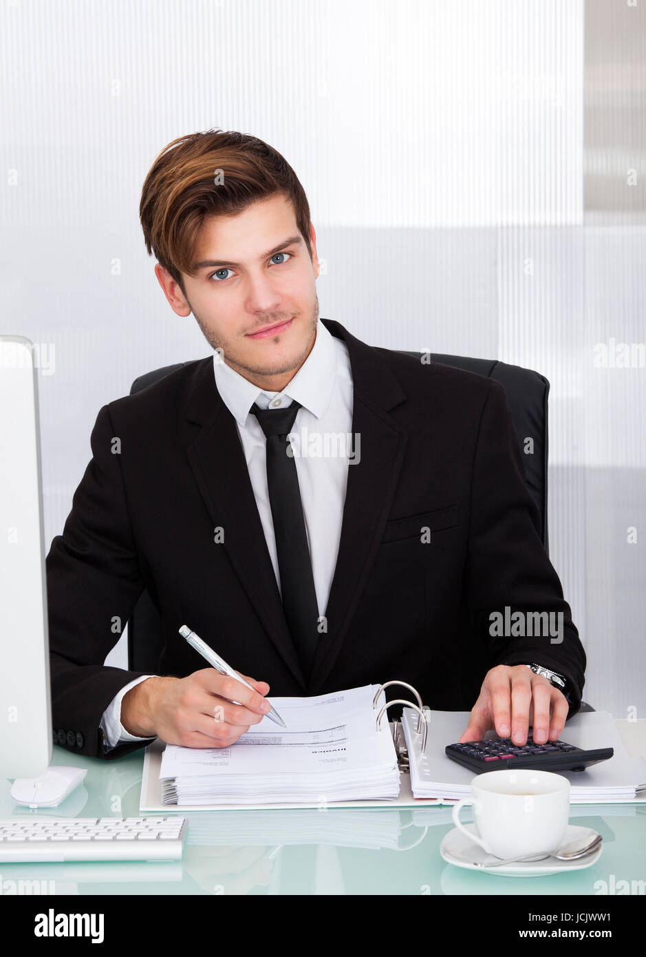 Serious businessman calculating bills hi-res stock photography and ...