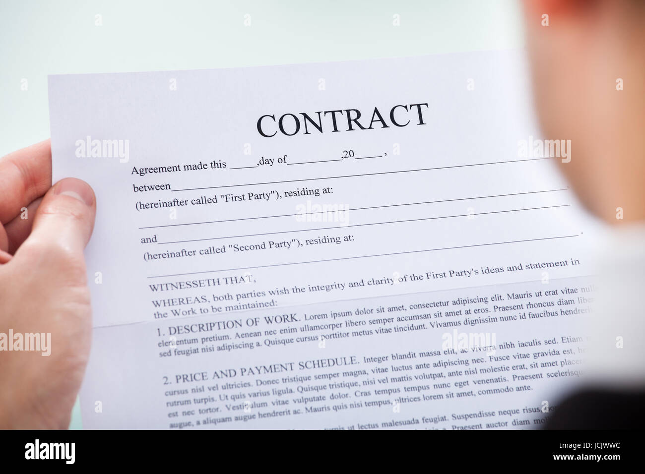 Close-up Of A Businessman Reading Contract Paper Stock Photo - Alamy