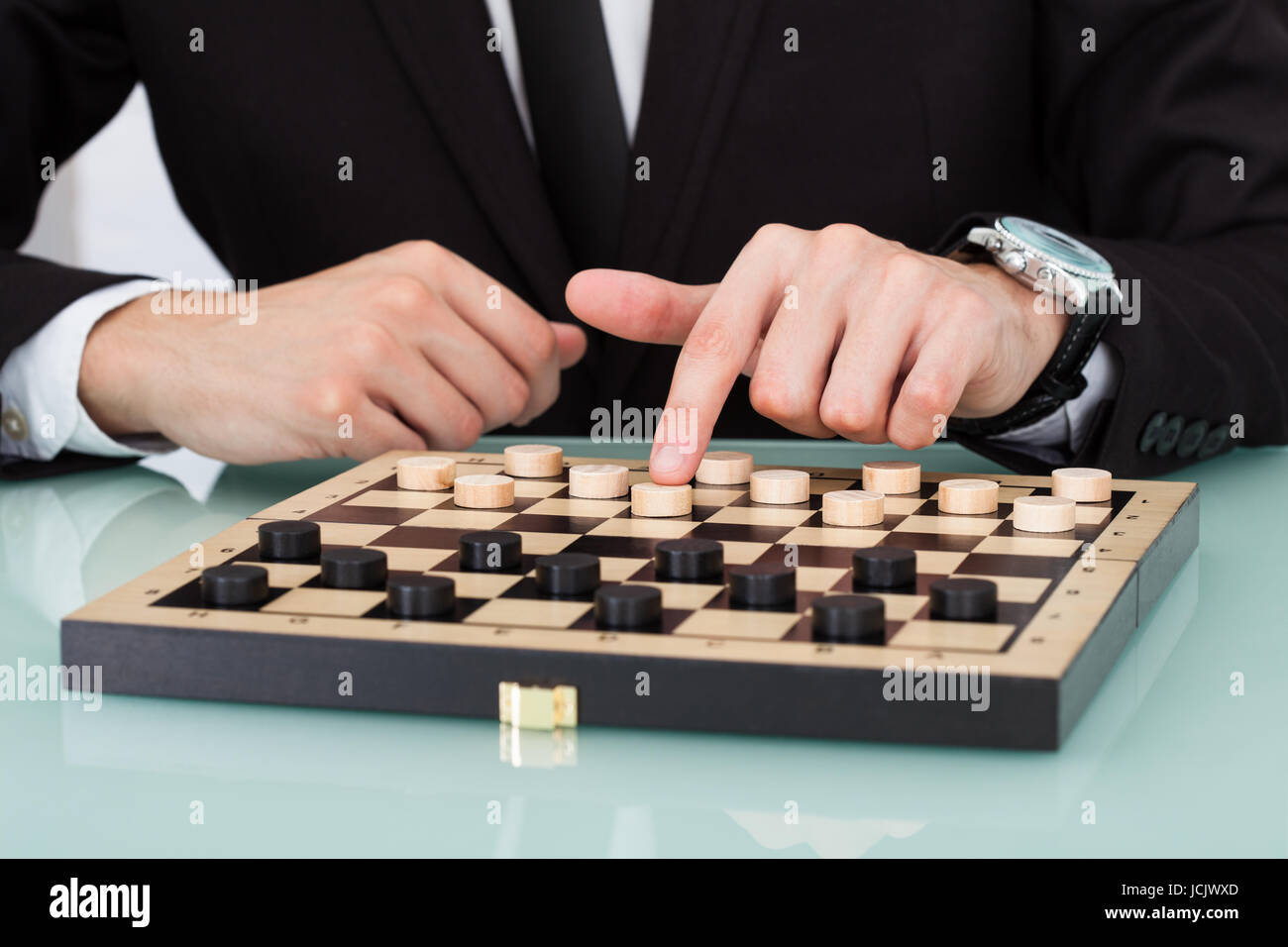 Close-up Businessman Playing Checkers At Office Desk Stock Photo - Alamy