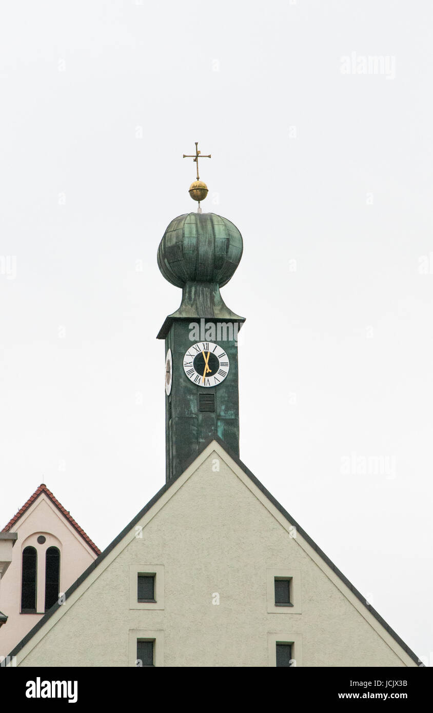 Clock tower with clock that has roman numberals and bulbous dome made ...