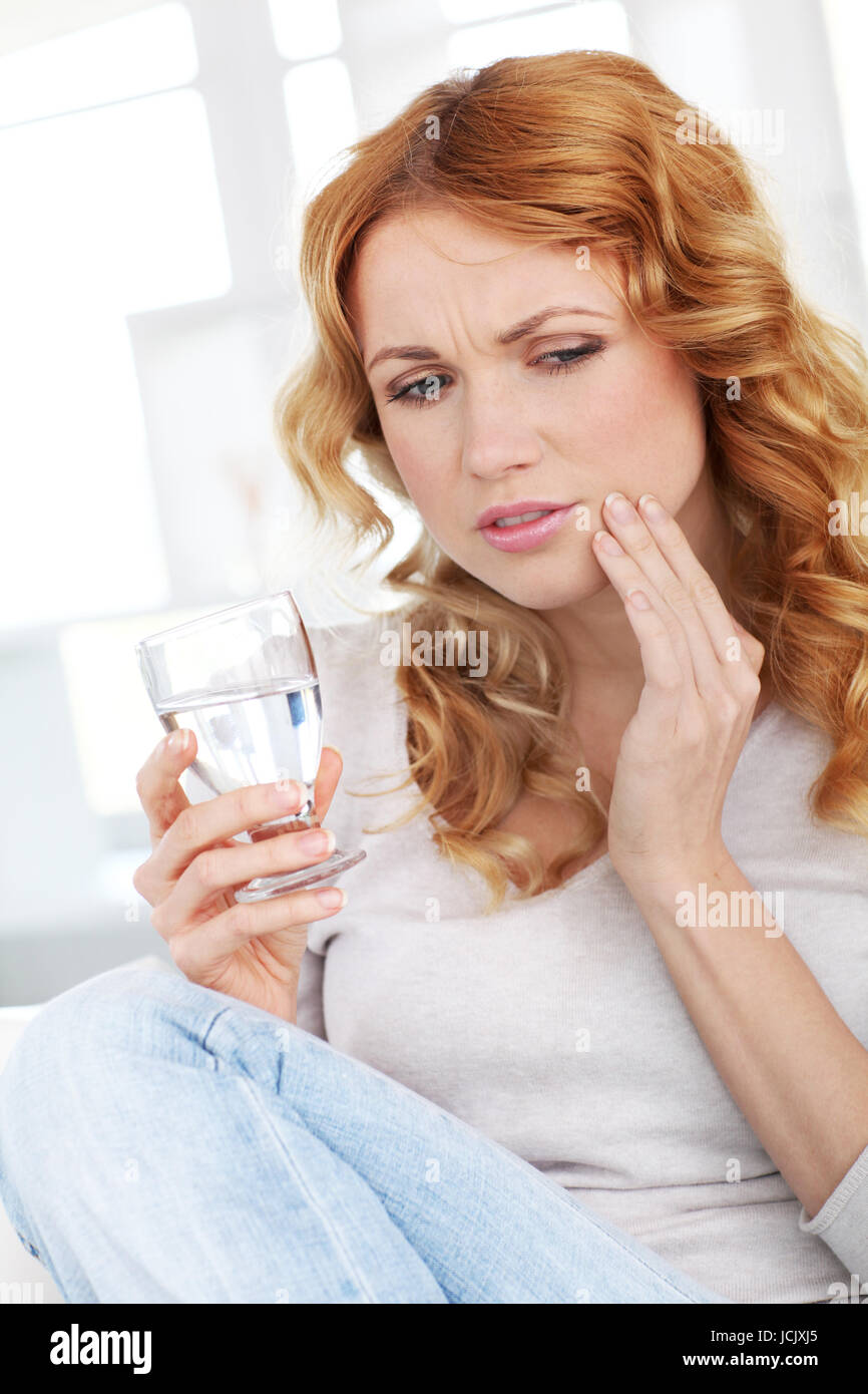 Beautiful blond woman having toothache Stock Photo - Alamy