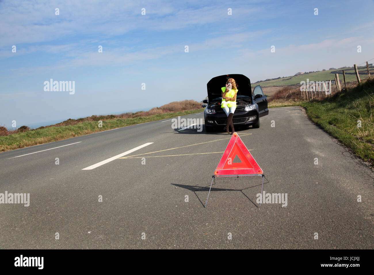 Warning triangle set on the road by broken down car Stock Photo - Alamy