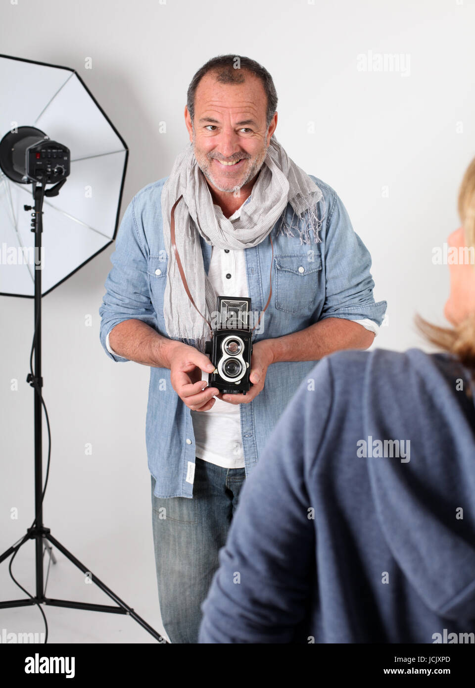 Photographer in photo session in studio Stock Photo - Alamy