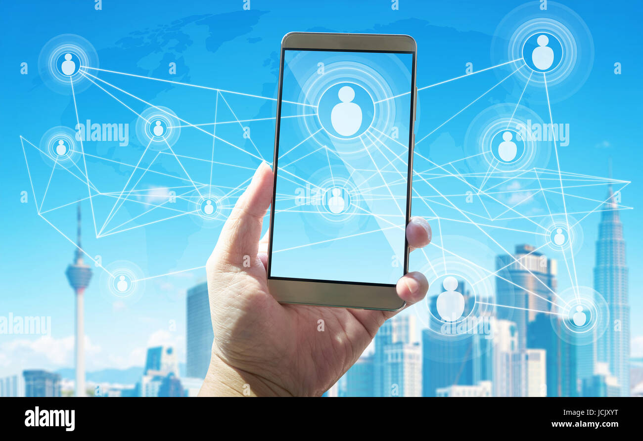 Unknown guy using smartphone with smart city and wireless communication ...