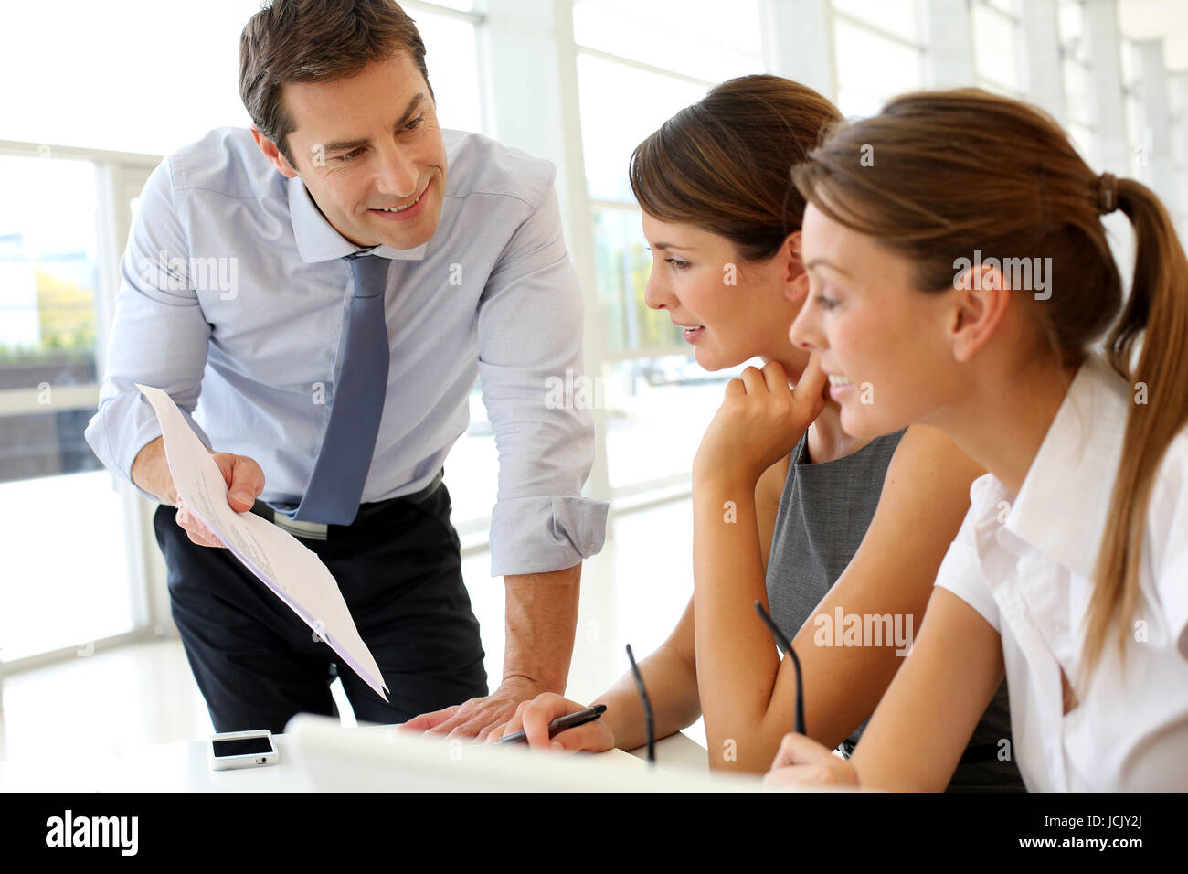Manager presenting business plan to employees Stock Photo - Alamy