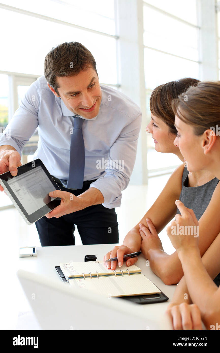 Manager presenting business plan with electronic tablet Stock Photo - Alamy