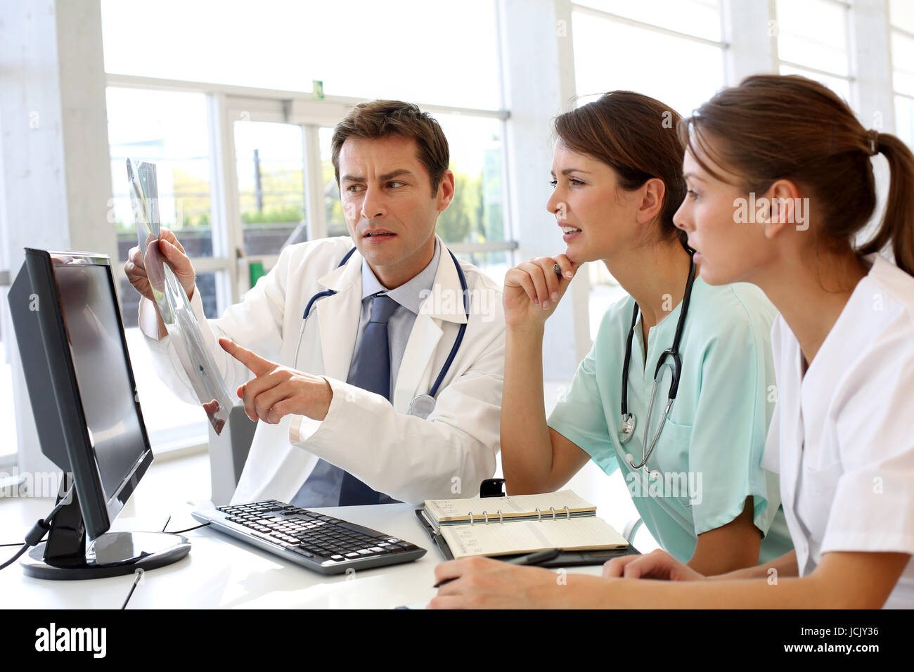 Medical team checking on X-ray results Stock Photo - Alamy