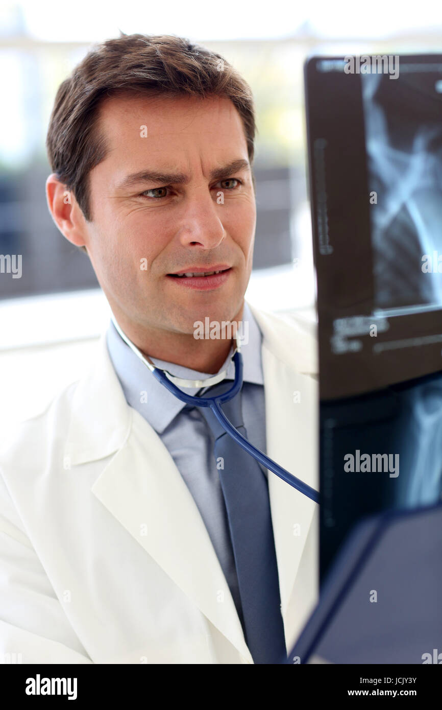 Doctor checking on patient Xray results Stock Photo - Alamy