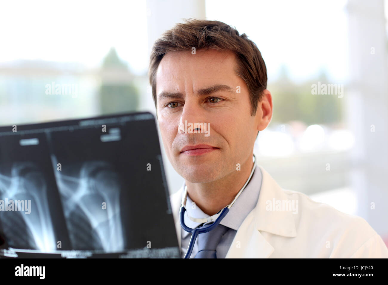 Doctor checking on patient Xray results Stock Photo - Alamy