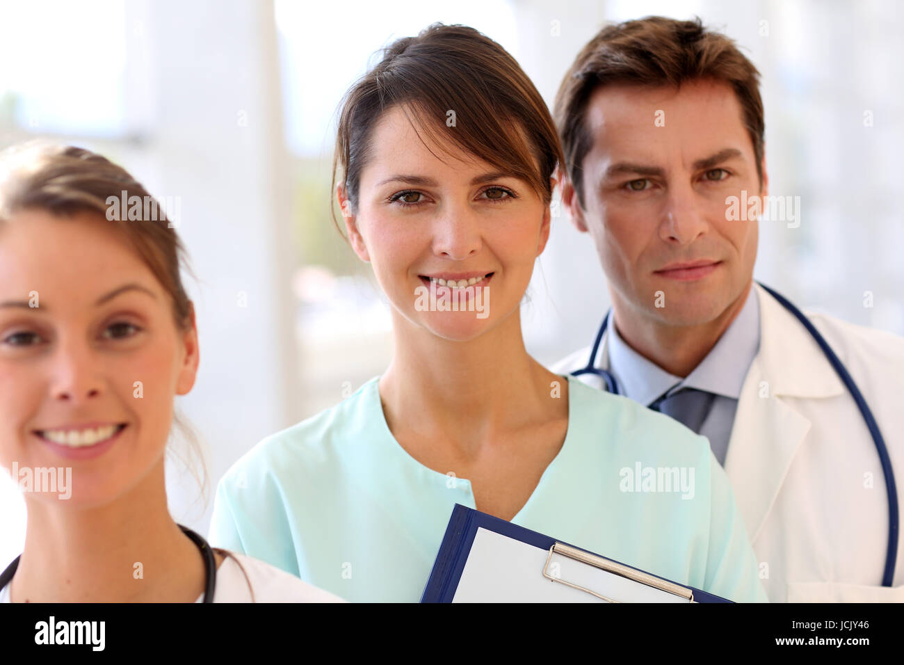 Smiling medical team standing in hall Stock Photo - Alamy