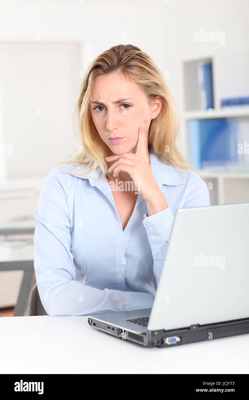 Office worker with doubtful look Stock Photo - Alamy