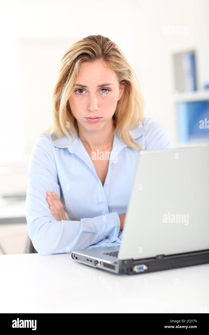 Office worker with bored look on her face Stock Photo - Alamy