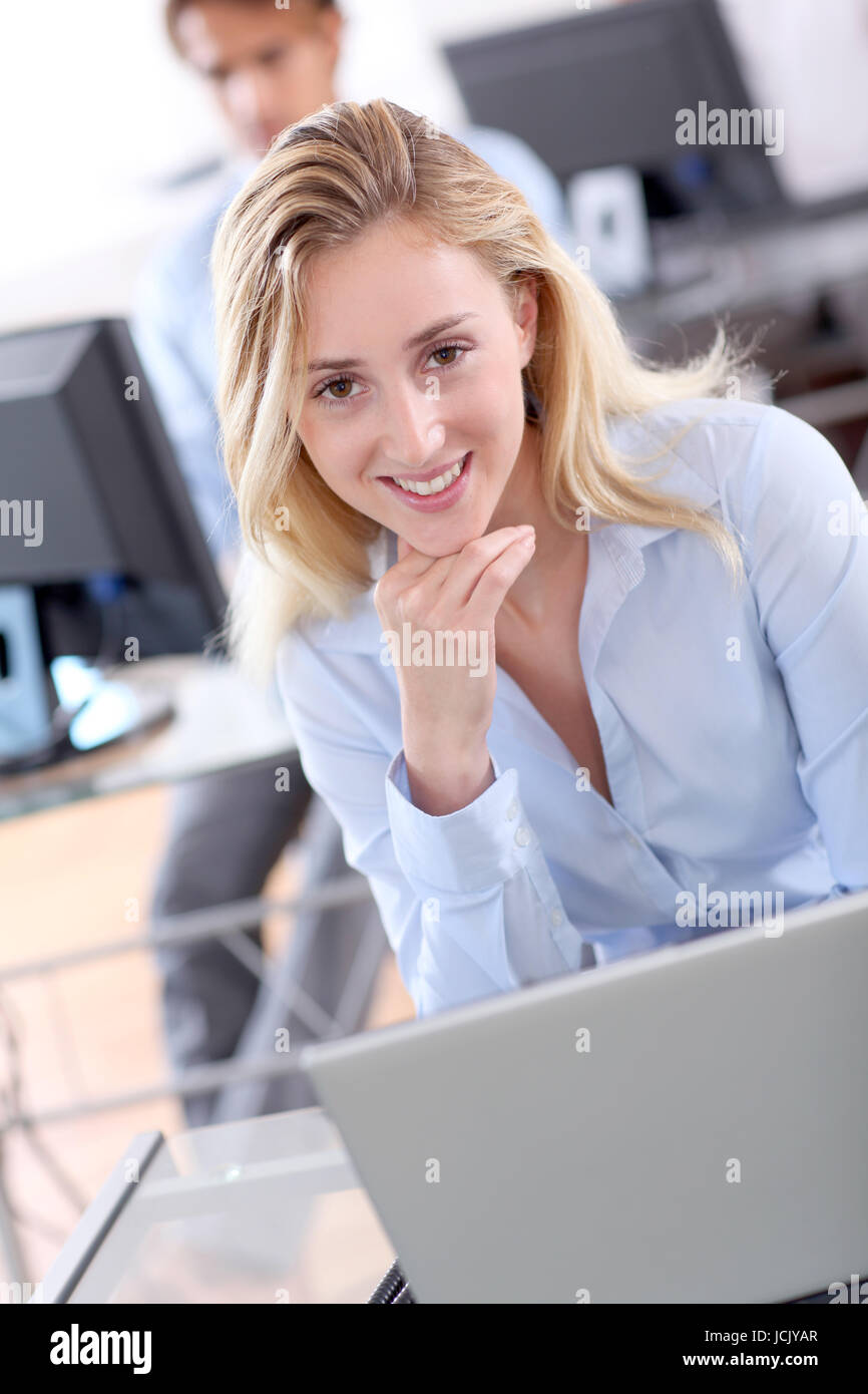 Beautiful woman in office working on laptop computer Stock Photo - Alamy