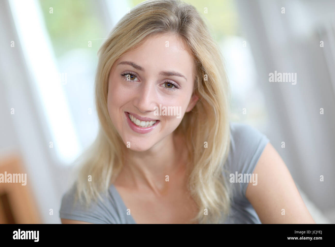 Beautiful smiling woman relaxing in sofa Stock Photo - Alamy