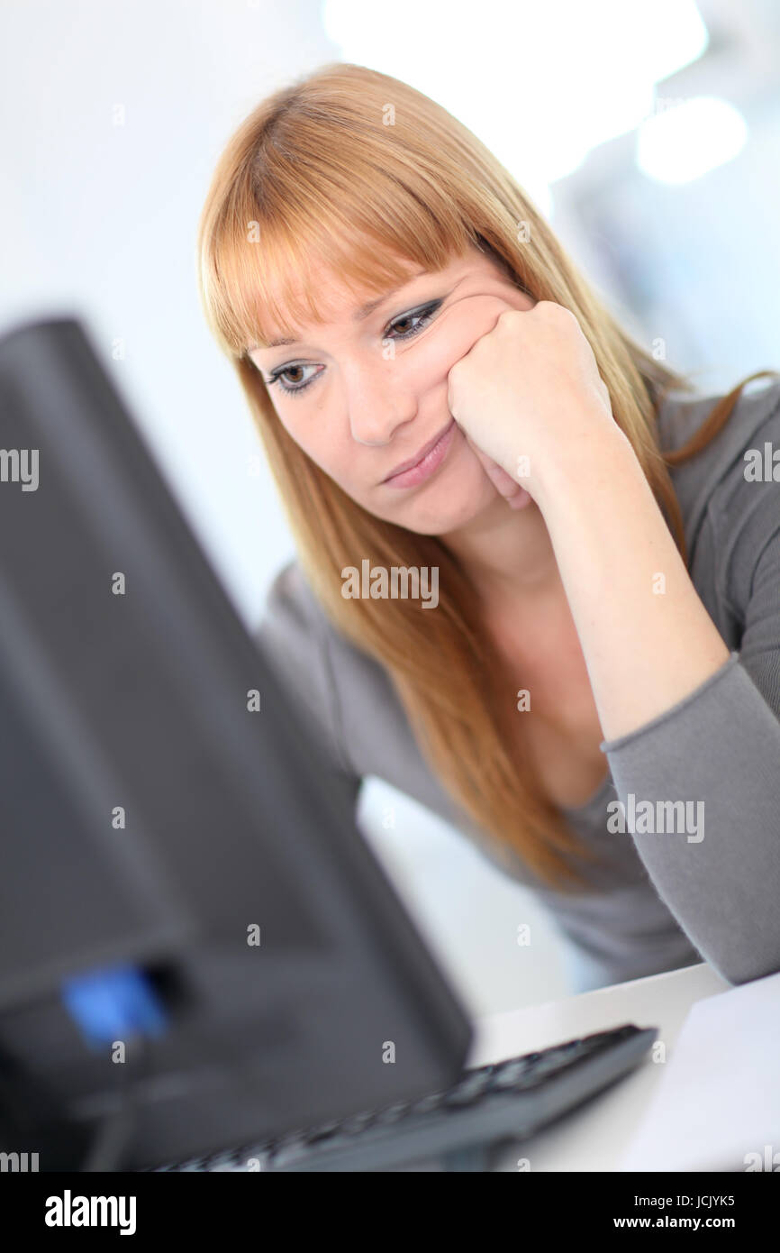Bored woman at work Stock Photo - Alamy