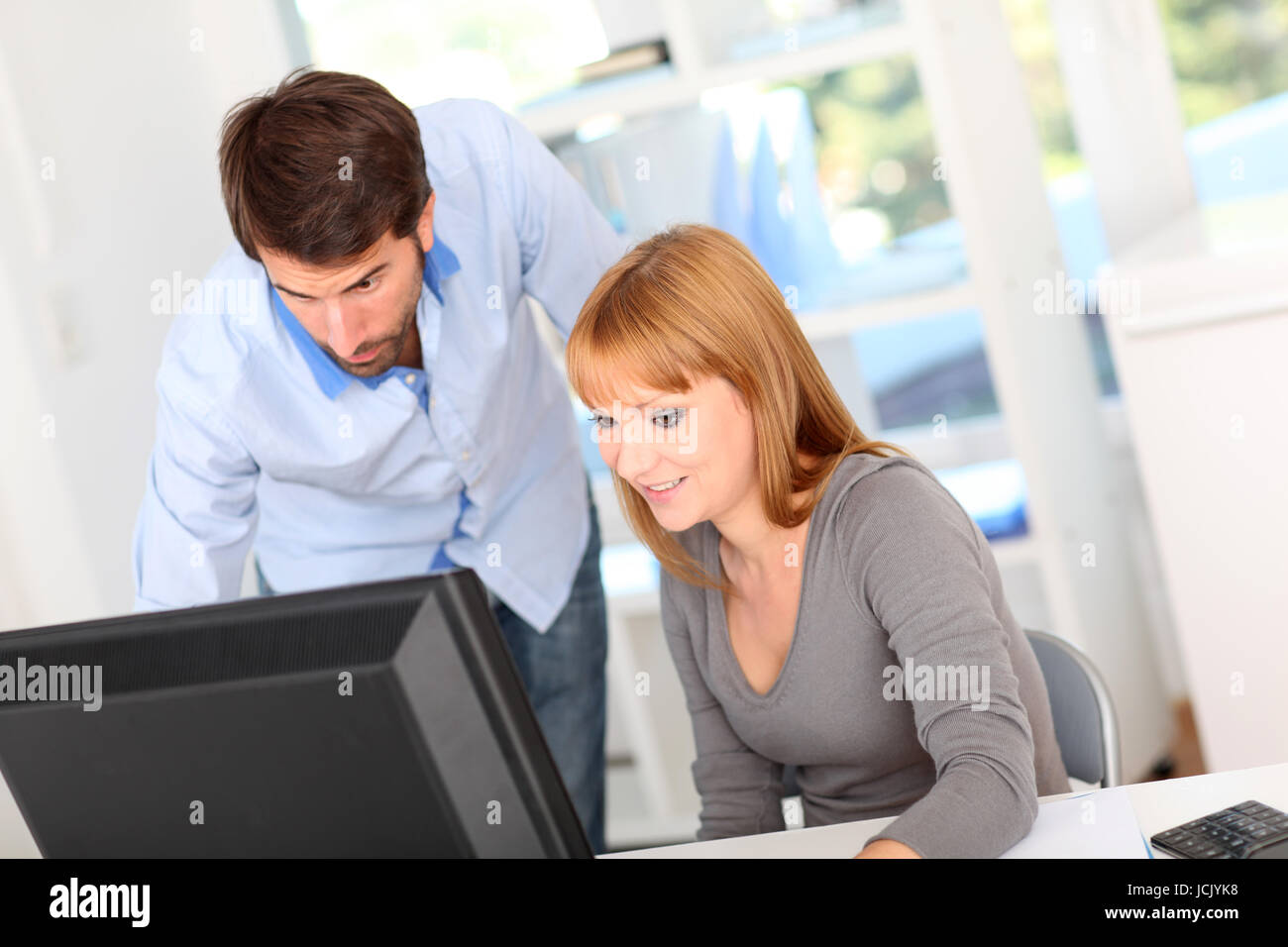Business people working on desktop computer Stock Photo - Alamy