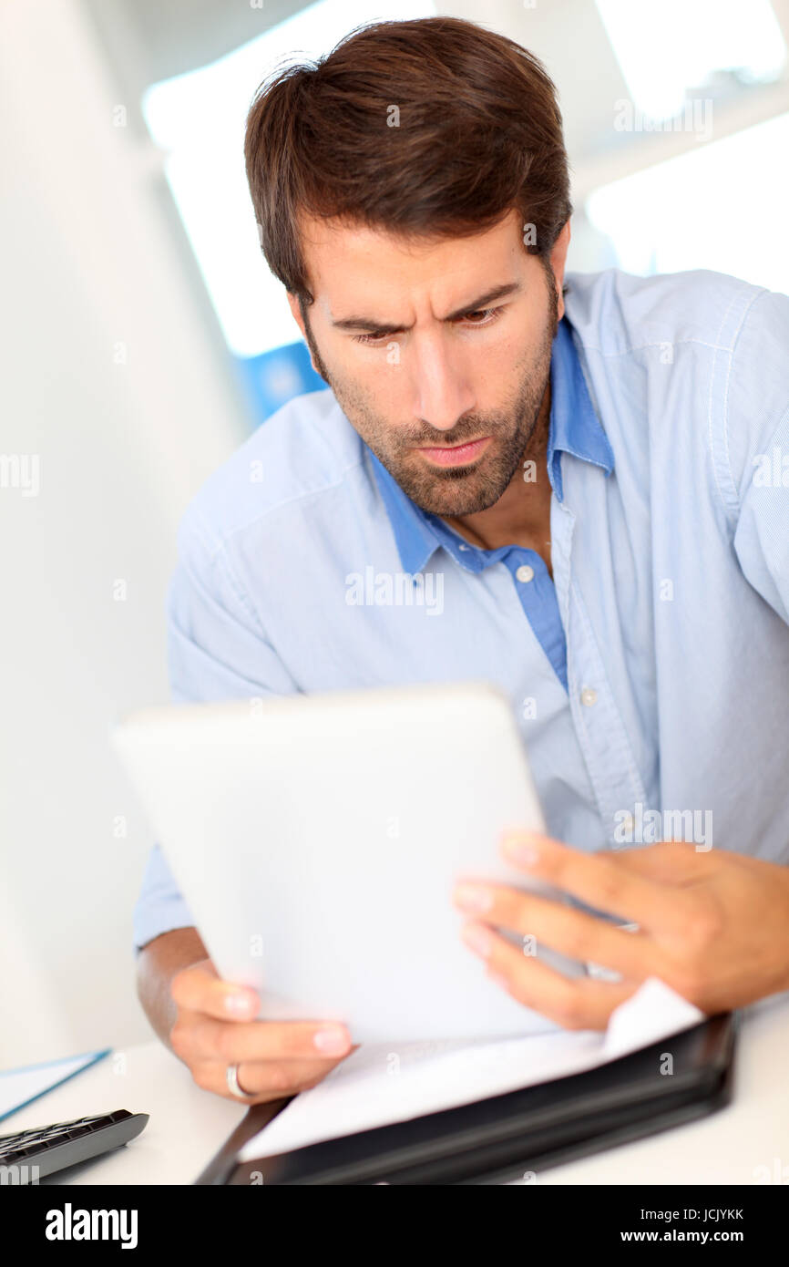 Portrait of office worker using electronic tablet Stock Photo - Alamy