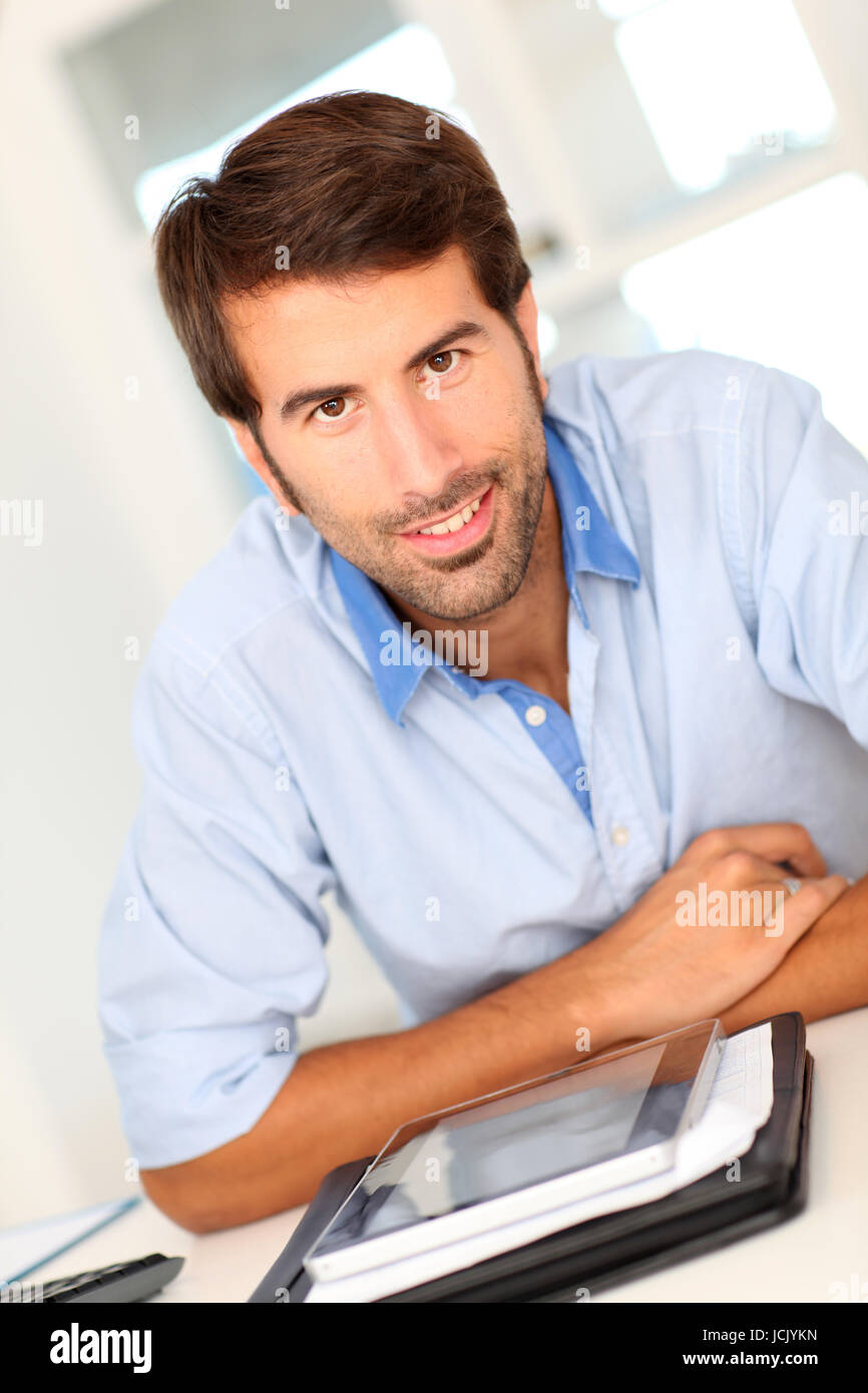 Portrait of office worker using electronic tablet Stock Photo - Alamy