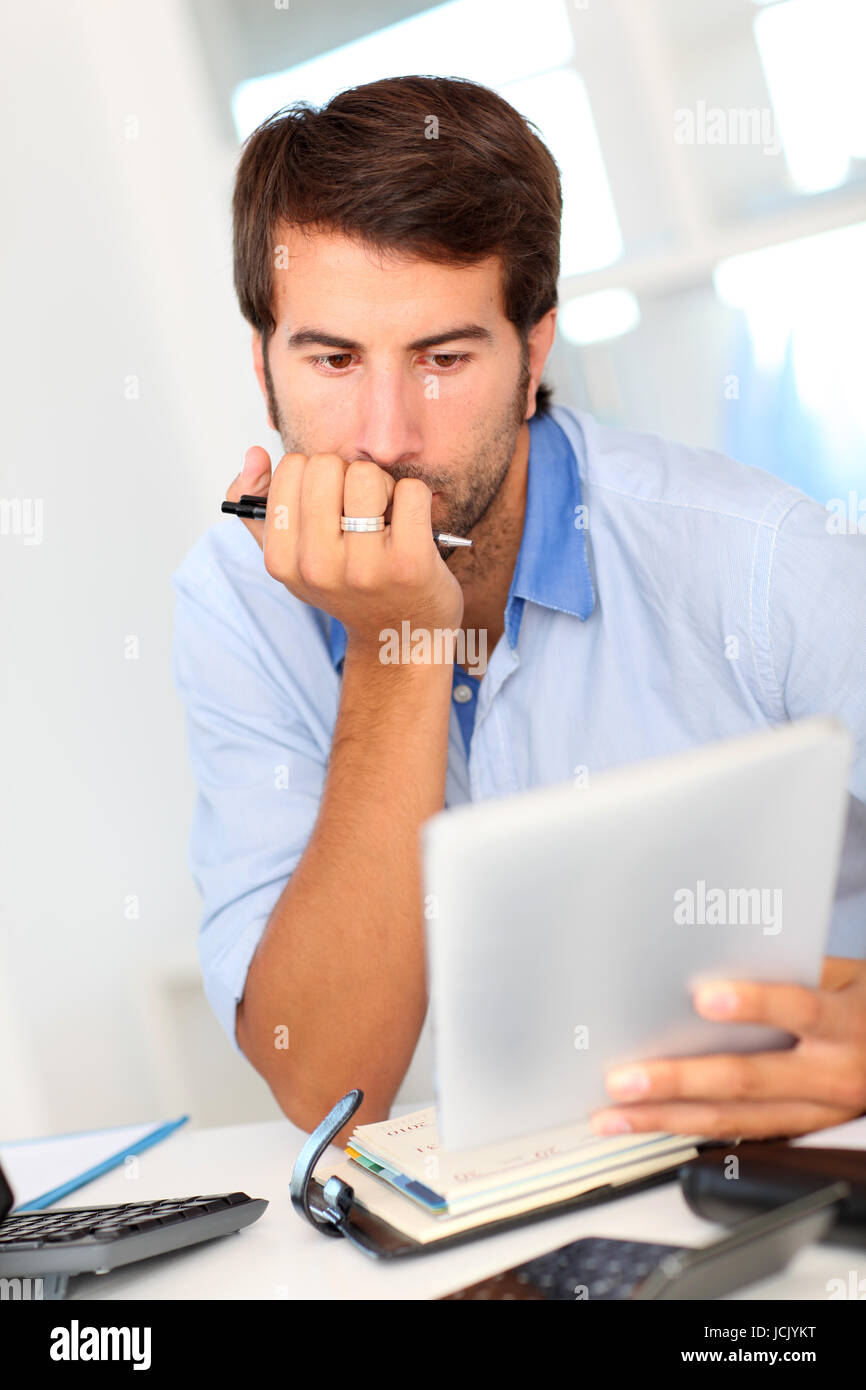 Portrait of office worker using electronic tablet Stock Photo - Alamy