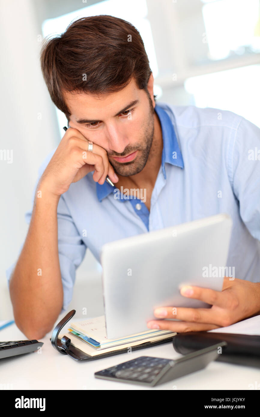 Portrait of office worker using electronic tablet Stock Photo - Alamy
