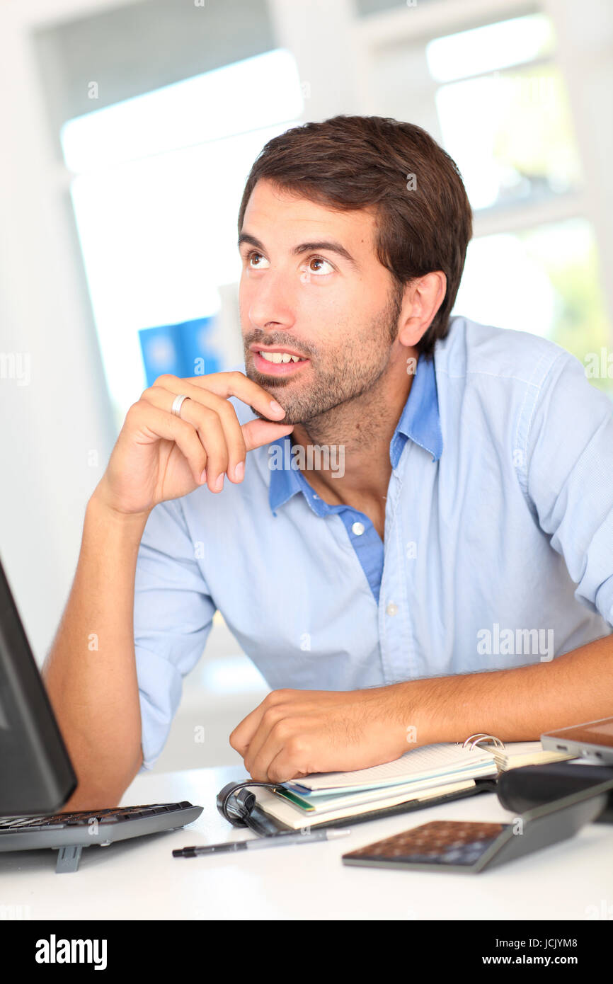 Office worker with thoughtful look Stock Photo - Alamy