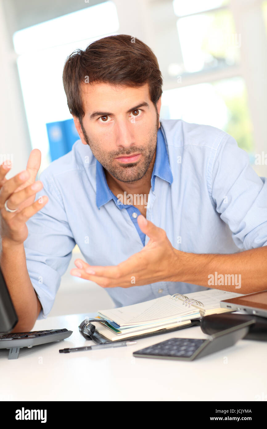 Portrait of salesman explaining somtehing to client Stock Photo - Alamy