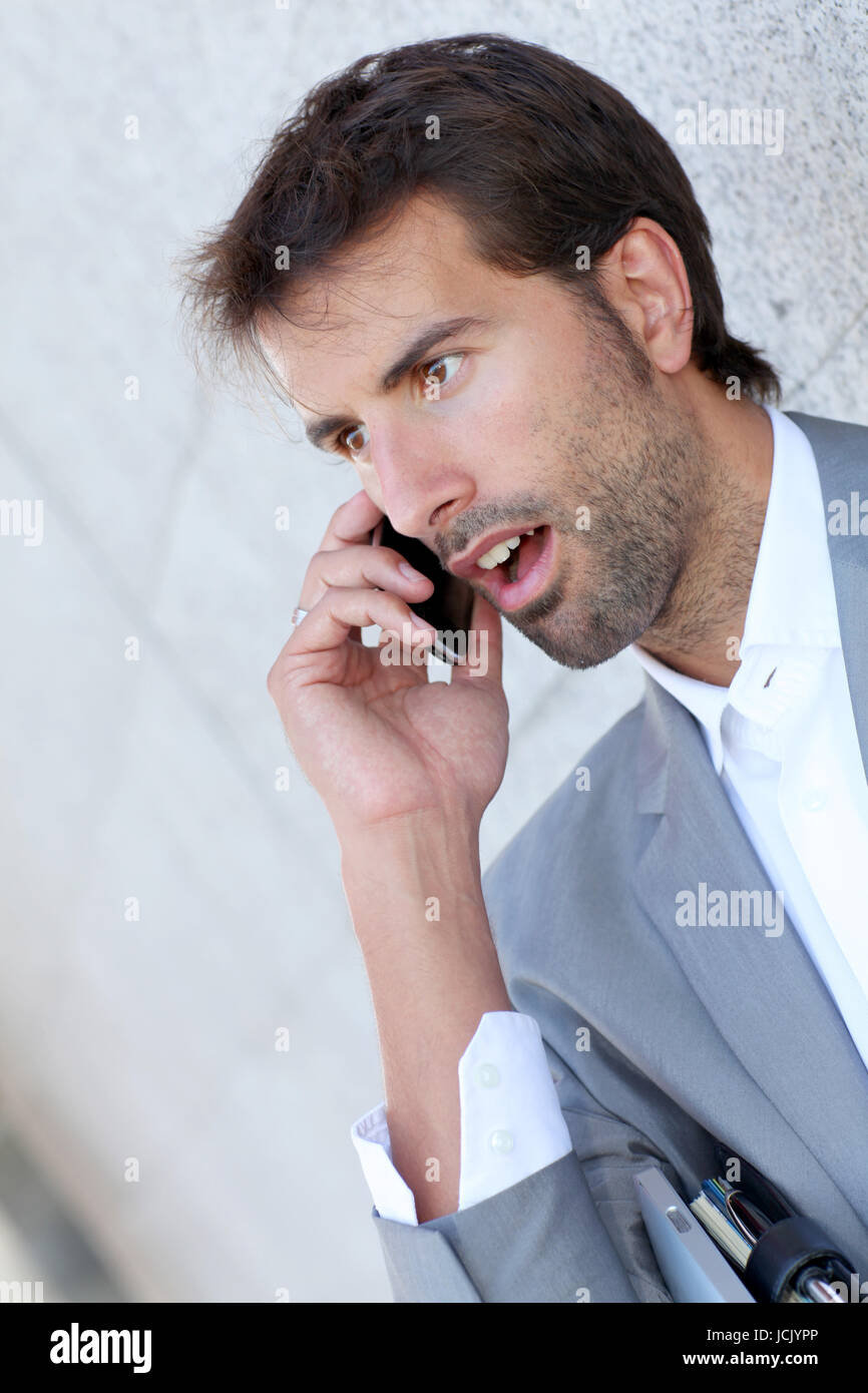 Portrait of salesman talking on mobile phone Stock Photo - Alamy