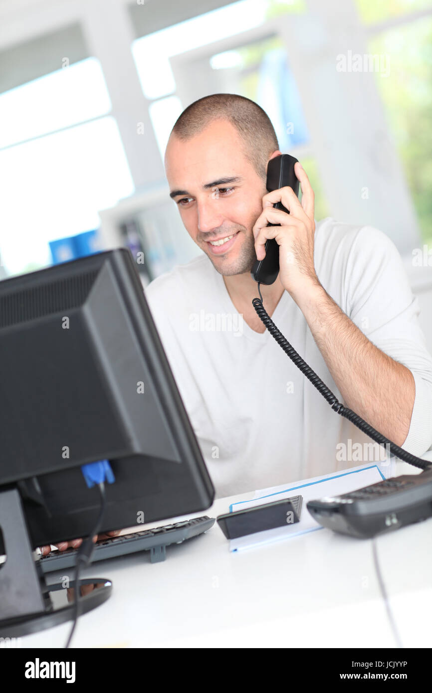 Smiling man answering the phone Stock Photo - Alamy