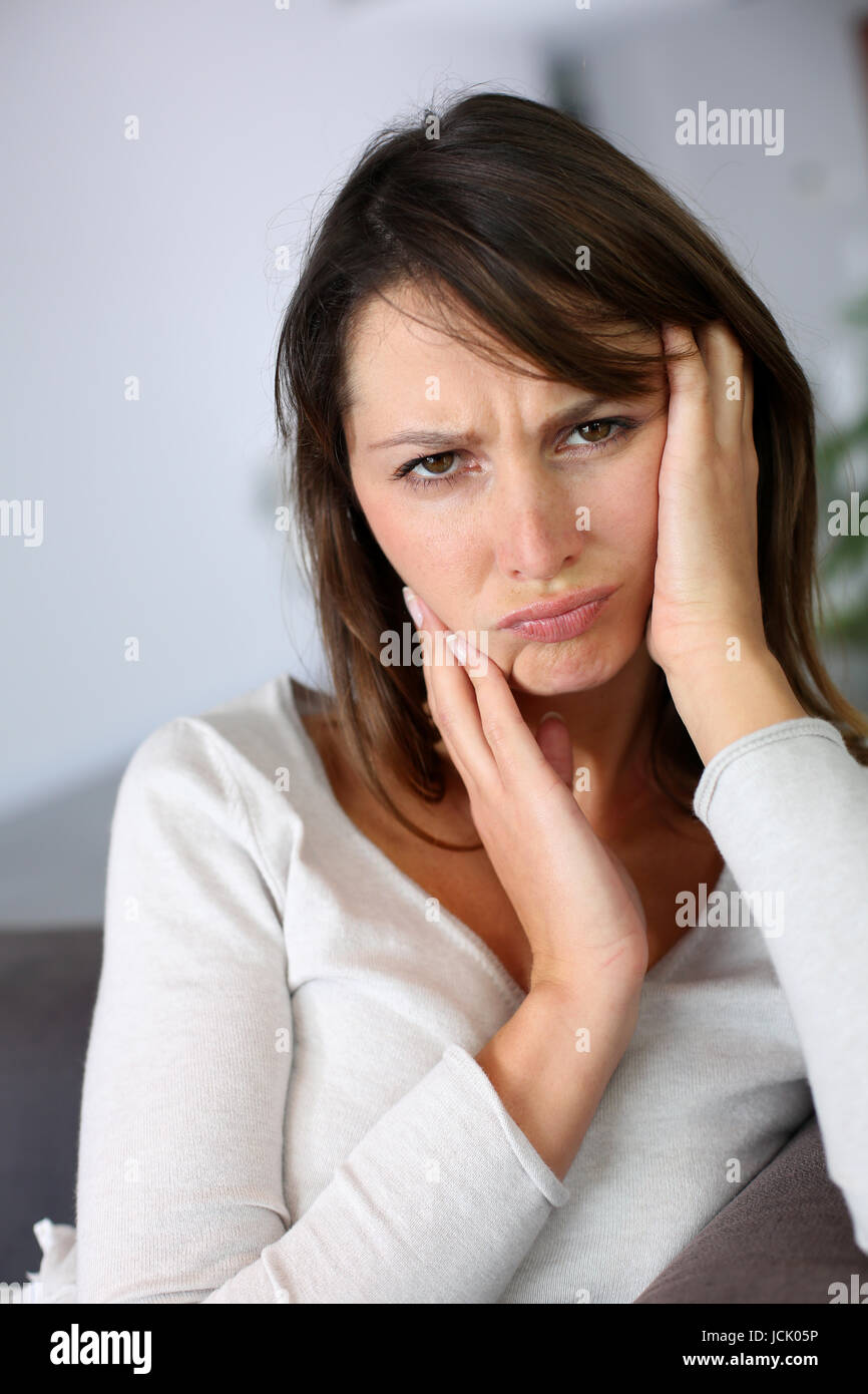 Brunette girl with upset look on her face Stock Photo - Alamy