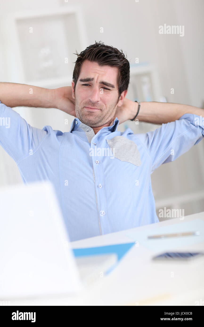 Office worker stretching arms at work Stock Photo - Alamy
