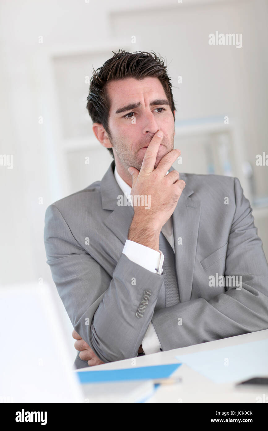 Businessman with doubtful look Stock Photo - Alamy