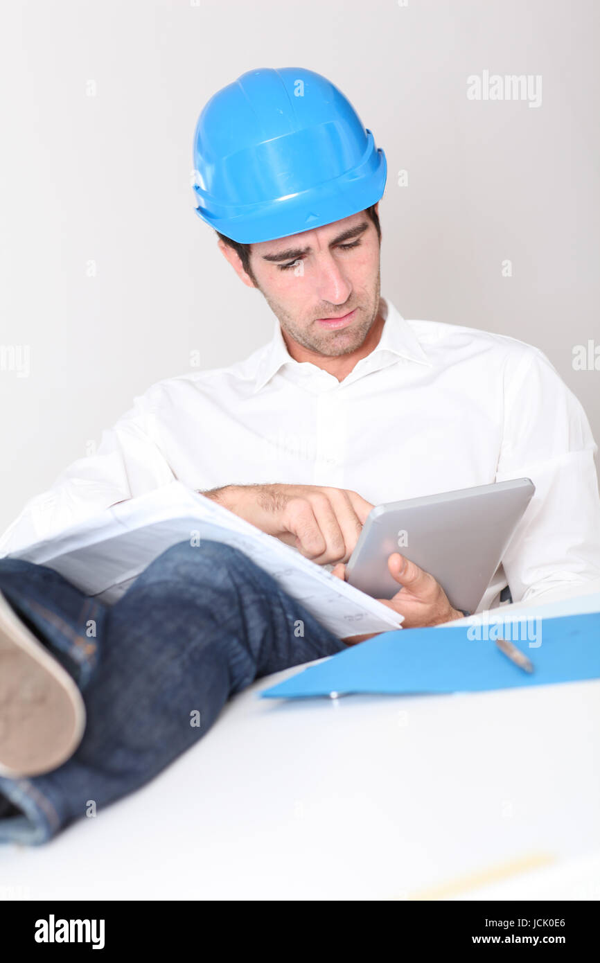 Site manager in office using electronic tablet Stock Photo - Alamy
