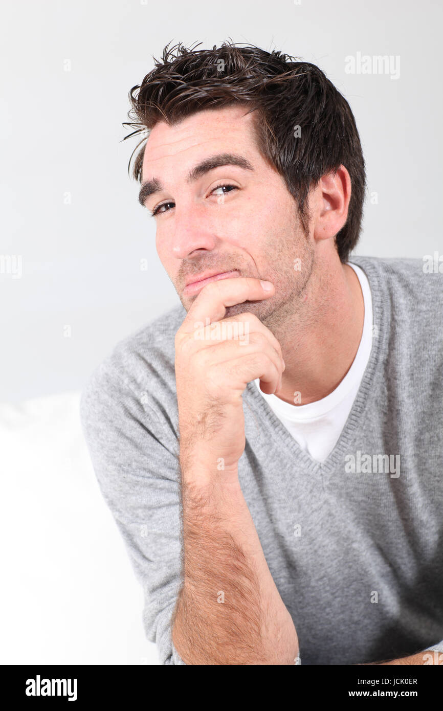 Portrait of handsome guy with hand on chin Stock Photo - Alamy