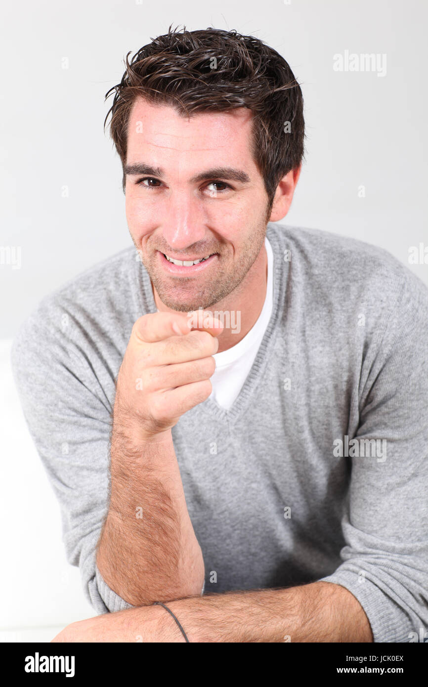 Portrait of handsome man pointing at camera Stock Photo - Alamy