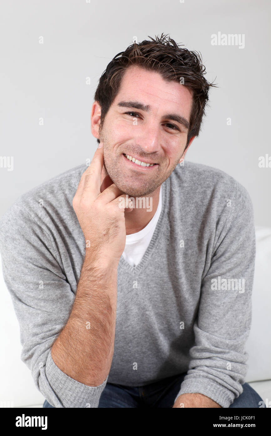 Portrait of handsome guy with hand on chin Stock Photo - Alamy