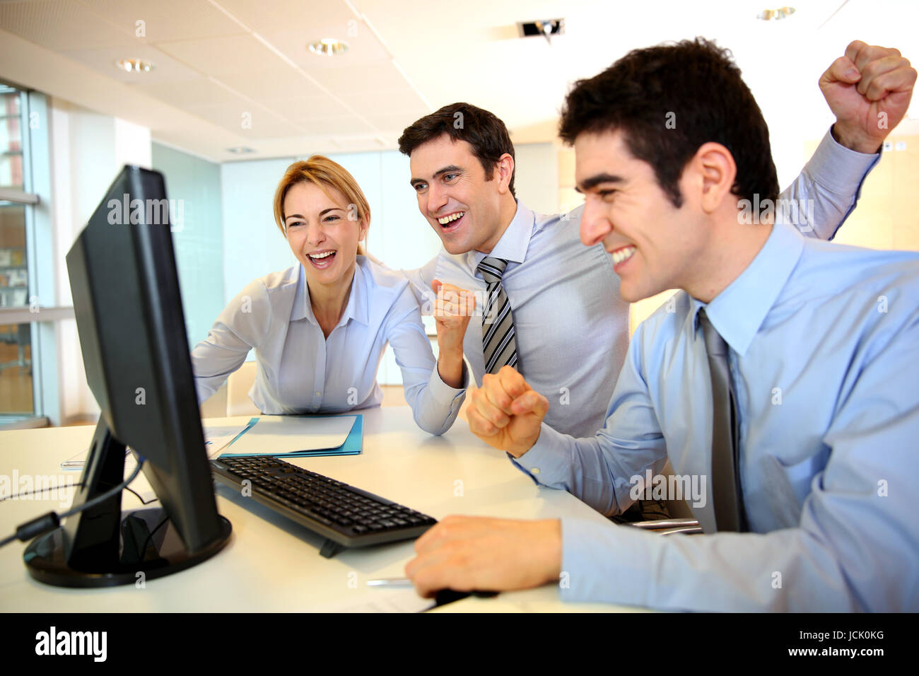 Cheerful sart-up team shouting in office Stock Photo - Alamy