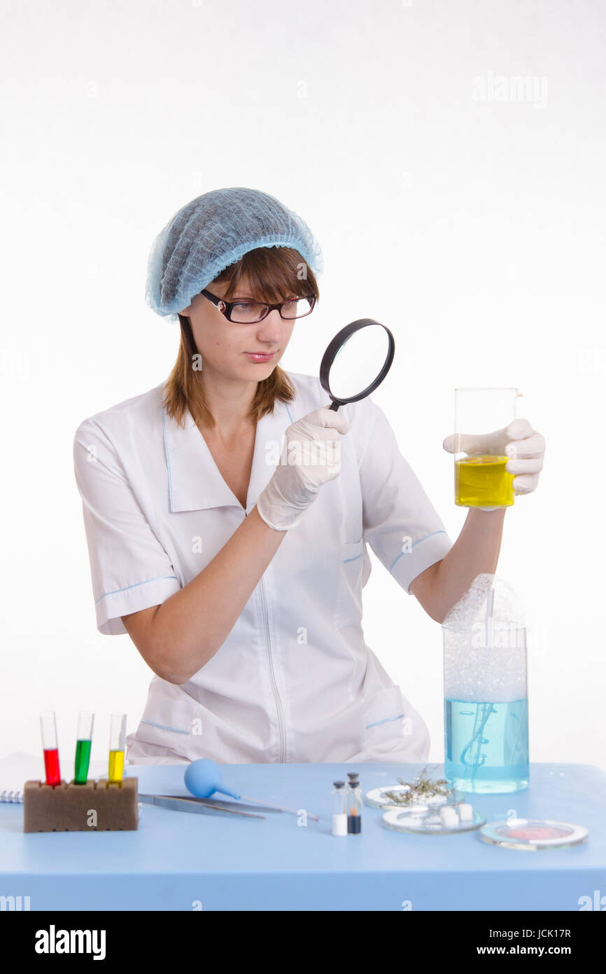 Young beautiful girl posing chemical experiments in the laboratory ...