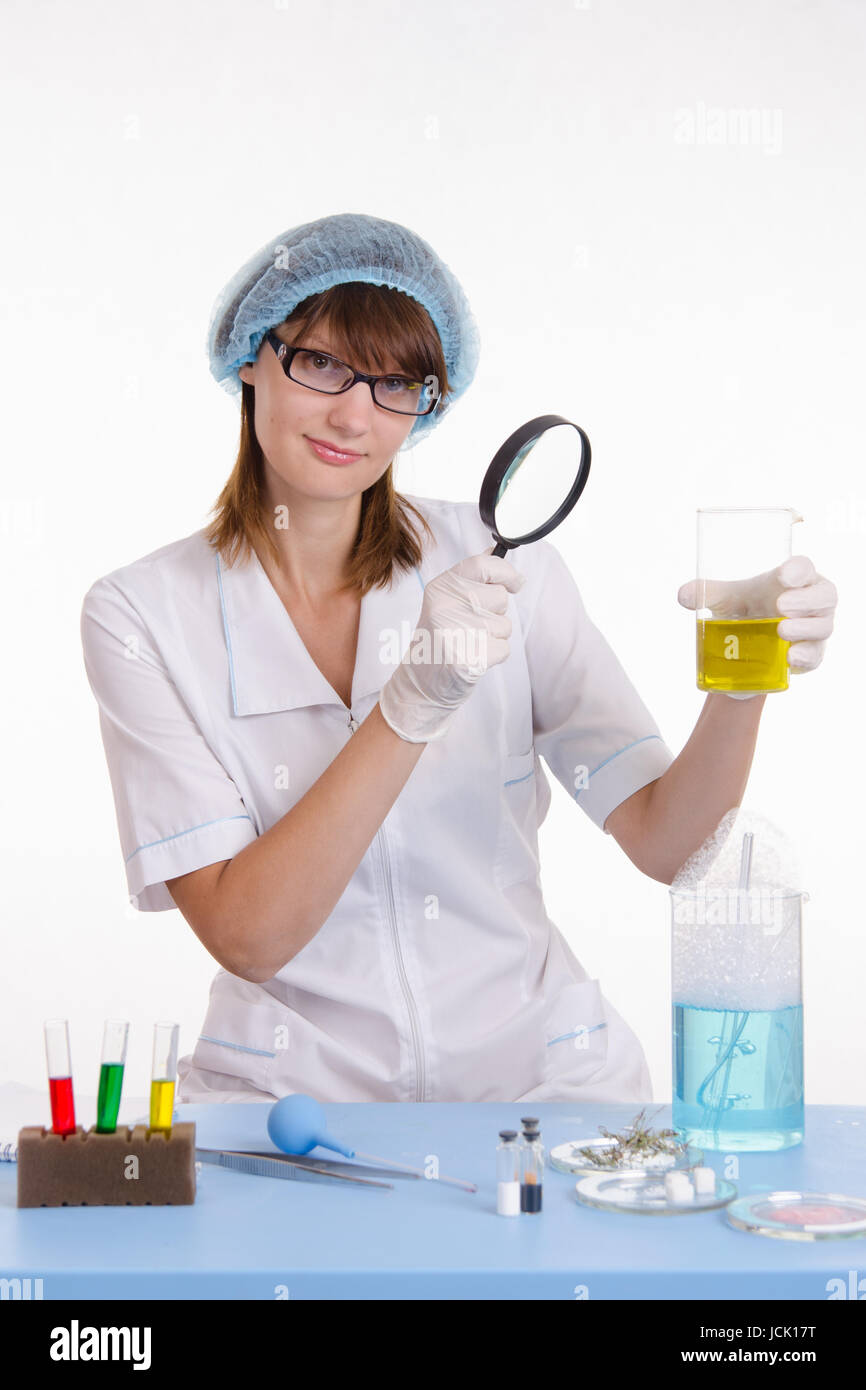 Young beautiful girl posing chemical experiments in the laboratory ...