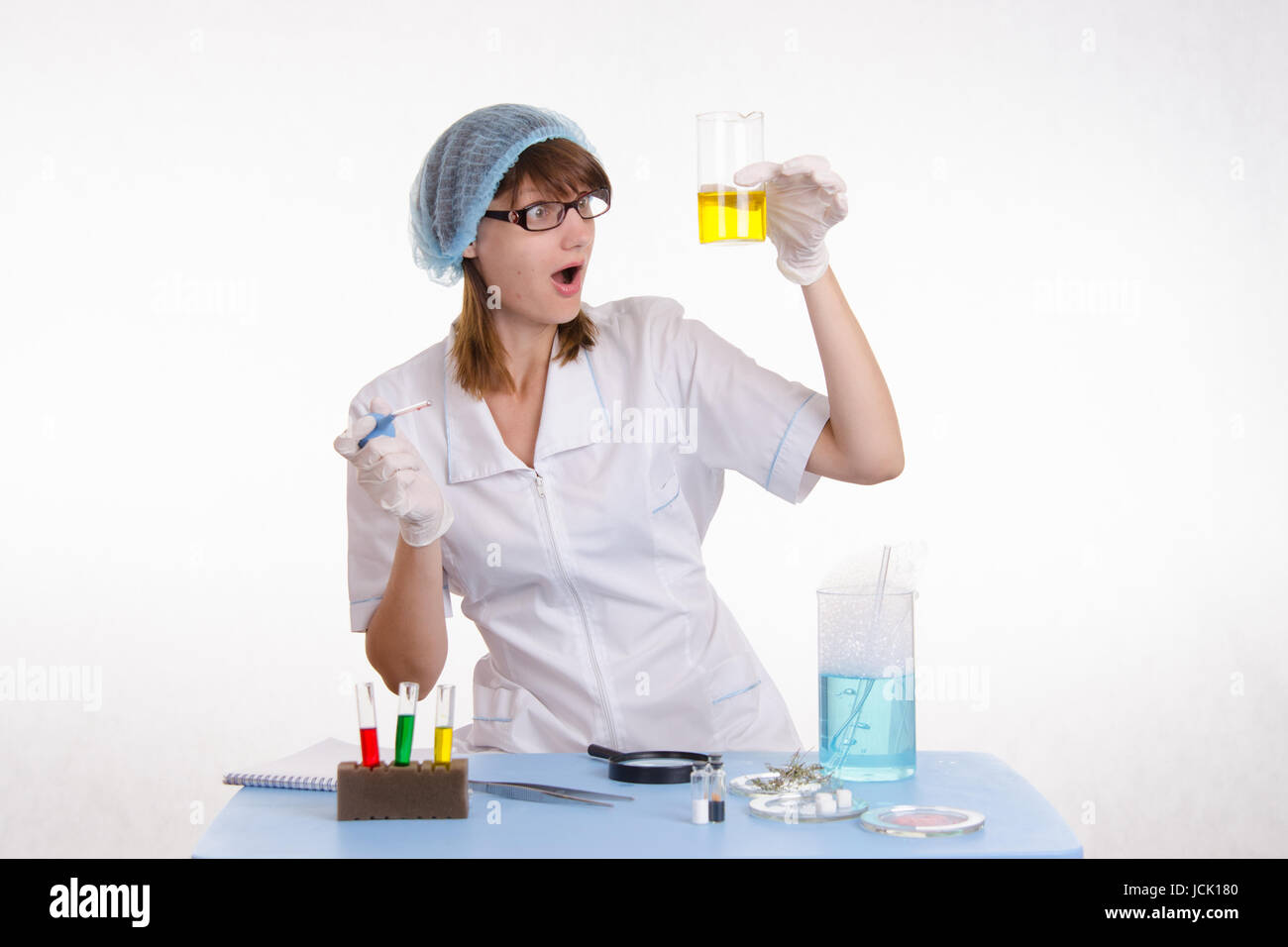 Young beautiful girl posing chemical experiments in the laboratory ...