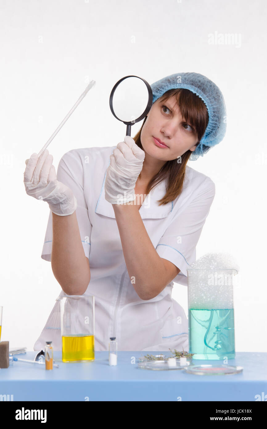 Young beautiful girl posing chemical experiments in the laboratory ...