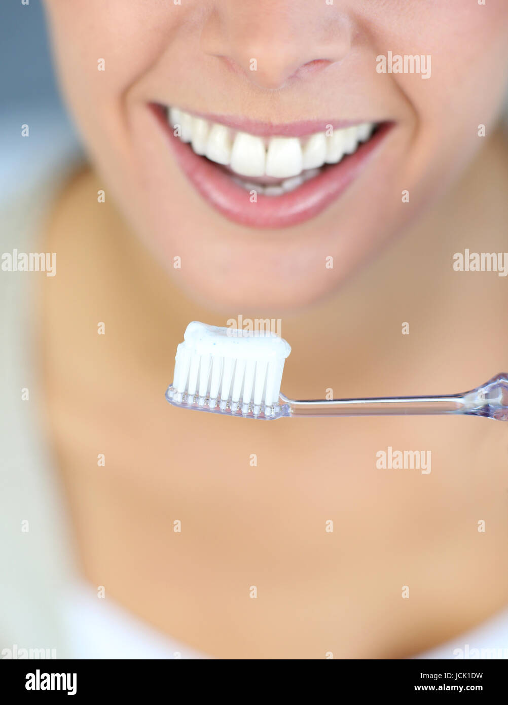 Closeup on woman's toothy smile brushing her teeth Stock Photo - Alamy