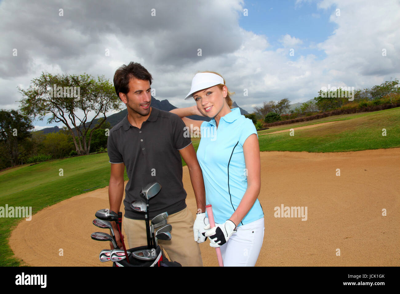 Couple playing golf Stock Photo - Alamy