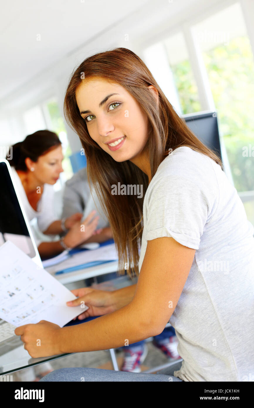 Beautiful office worker sitting in front of desktop Stock Photo - Alamy