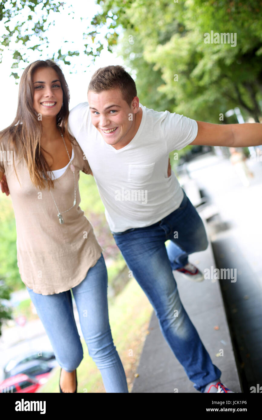 Friends having fun out in the street Stock Photo - Alamy